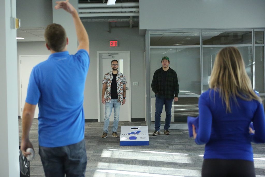 Employees of Ally compete in the cornhole tournament.